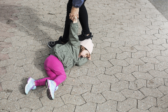 Mother dragging her crying daughter on sidewalk Stock Photo by ...
