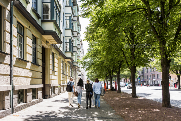 Students walking together on street outside library. Stock Photo by ...