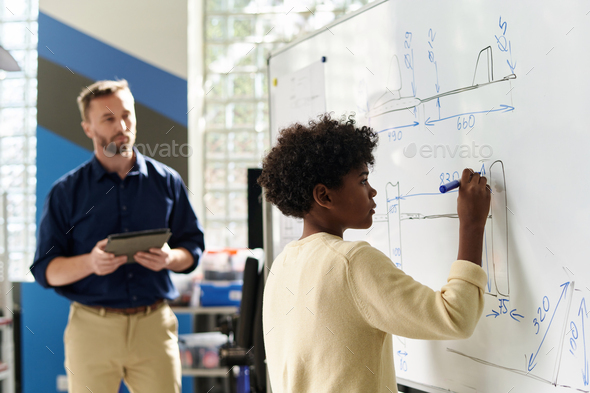Schoolboy Writing Dimensions of Airplane Stock Photo by seventyfourimages