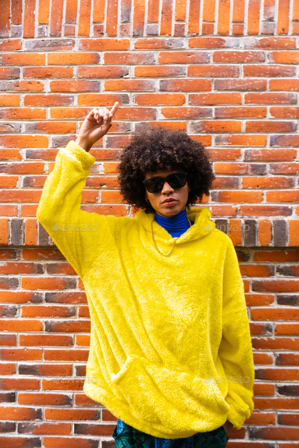 fashionable afro mexican man with cool attitude is pointing copy space ...