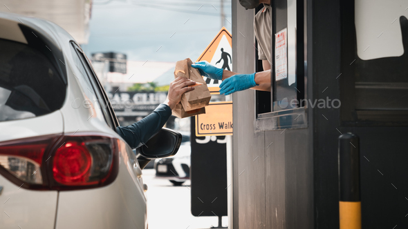 Young Man receiving coffee at drive thru counter., Drive thru and take ...