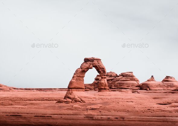 View of a rocky arch under the bright sky in the arches national park ...