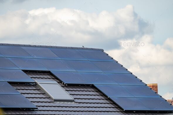Scenic view of a modern home roof covered with multiple solar panels ...