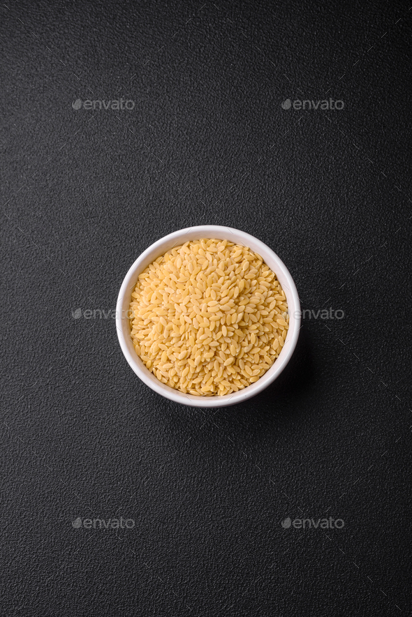 Raw whole grain orzo pasta as an ingredient for a delicious dish Stock ...