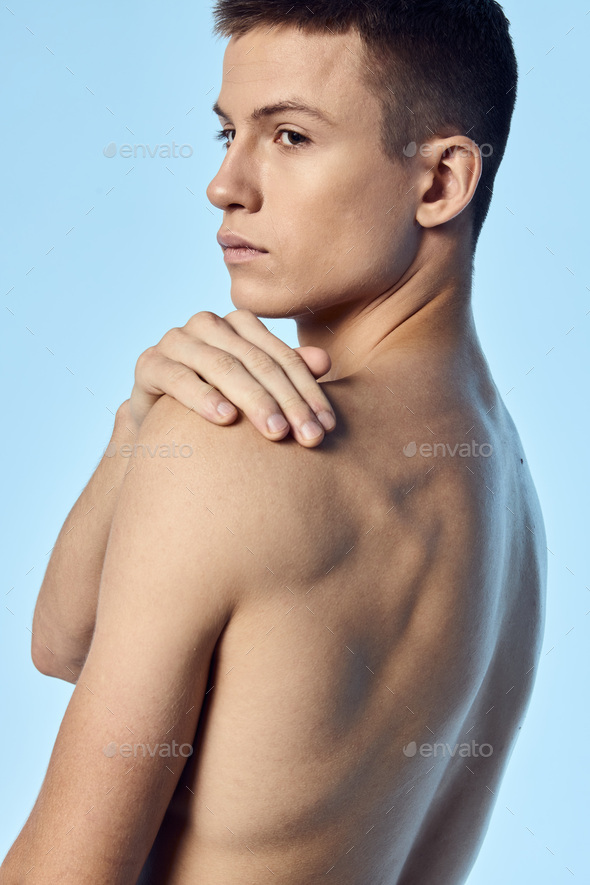 sports man holding hand on shoulder back view muscles athlete blue ...