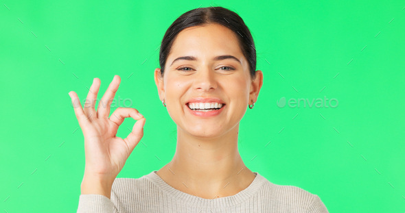 Face, green screen and woman with ok sign, smile and approval against a ...