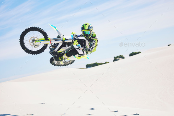 Motorbike, person and jump with fitness, challenge and training with ...