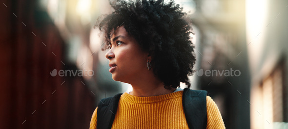 Profile of a female journalism student standing on campus outside. Face ...