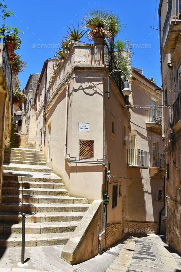 Vertical shot of the narrow street in Modica, an old town in Sicily in ...