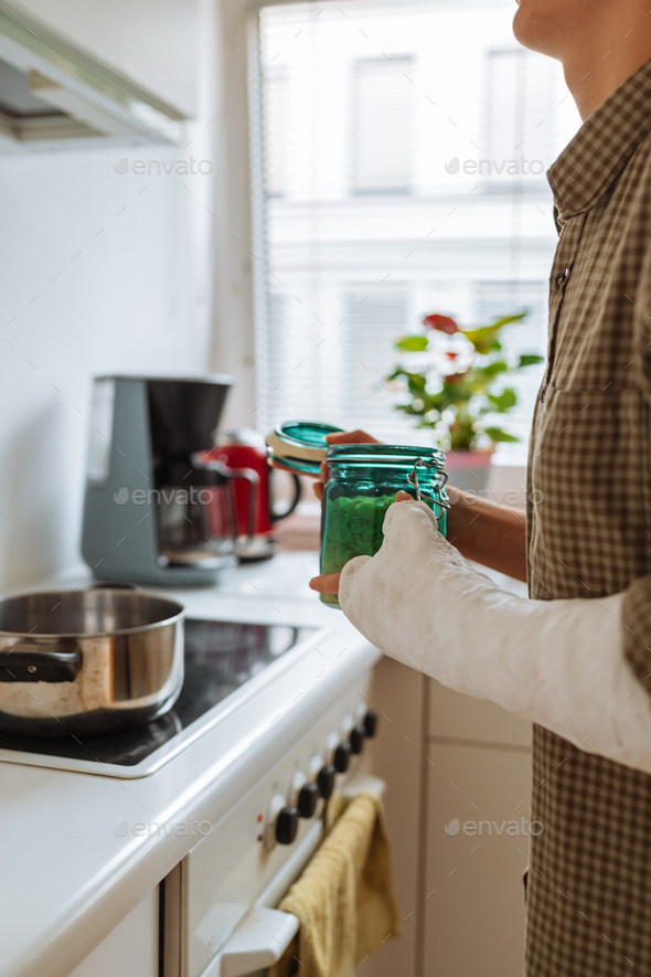 teenage girl, with cast on arm, cook lunch at home Stock Photo by ...