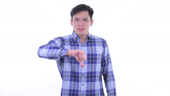 Angry Young Asian Hipster Man Giving Thumbs Down, Stock Footage | VideoHive