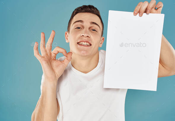 guy with flyer in hand mockup blue background cropped view Stock Photo ...