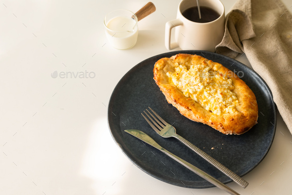 traditional Georgian cuisine. Open pie with mozzarella cheese. Ajara ...