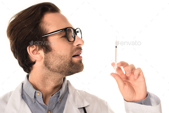 Side view of doctor looking at syringe isolated on white Stock Photo by ...