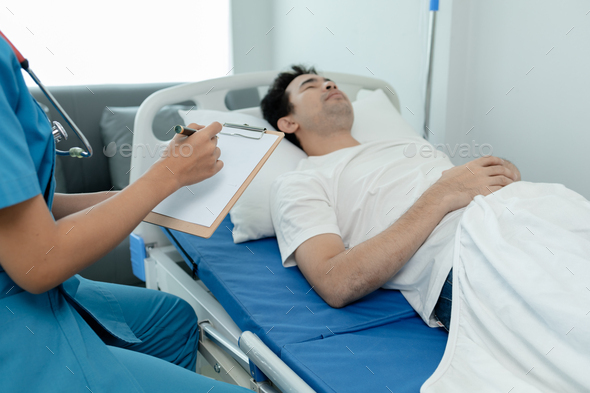 Patient on an inpatient hospital bed with a doctor examining and asking ...