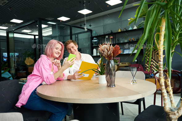 Guy and his girlfriend are sitting at a round table Stock Photo by ...