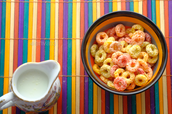 colorful ring corn flakes on color background. Stock Photo by towfiqu98