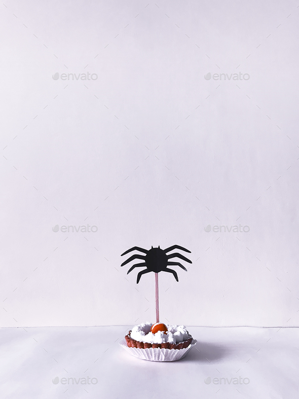 Black Paper Spider Decor On Creamy Cupcake On Purple Pastel Monochrome ...