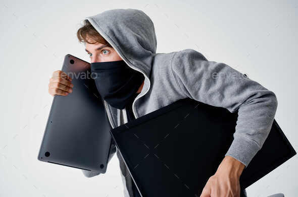 masked man hooded head hacking technology security light background ...