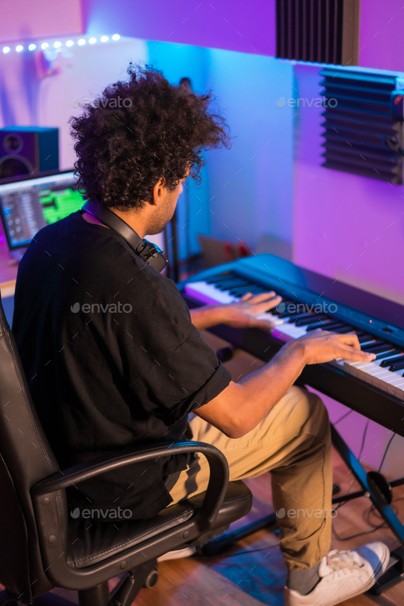Musician playing the piano sitting on a production studio Stock Photo ...