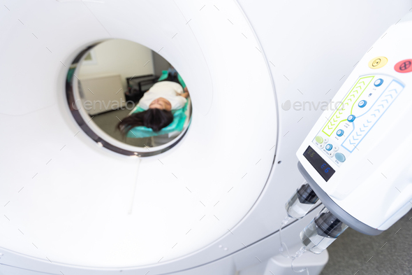 beautiful woman lying on ct scanner bed during tomography test in ...