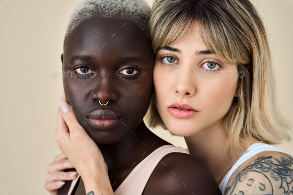 Cool diverse gen z girls beauty models on beige background, close up ...