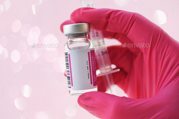Pink generic vaccine or injection treatment in vial with blank label ...