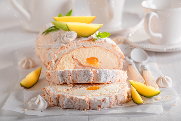 Sweet mango swiss roulade served as spring dessert. Stock Photo by Shaiith