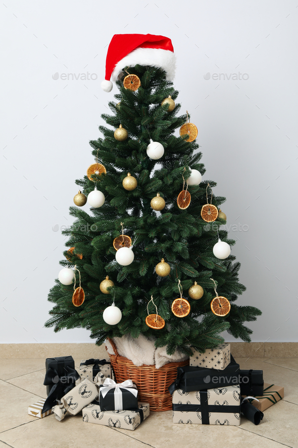 Christmas, decorated tree with a Santa hat on top. Stock Photo by ...