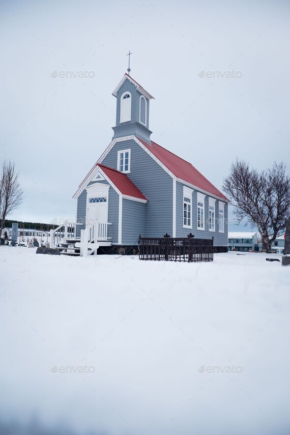 winter scene featuring a traditional church with a red roof and white ...