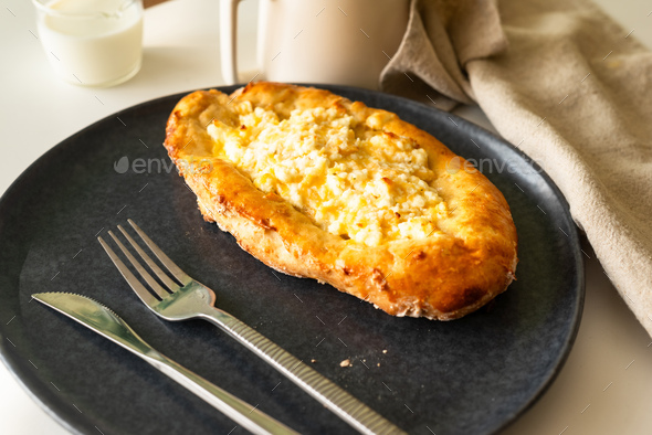 traditional Georgian cuisine. Open pie with mozzarella cheese. Ajara ...