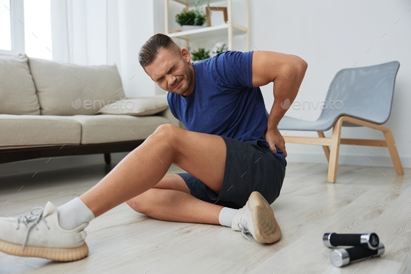 Man athlete pain and injury back arm and leg at home, sports injury ...