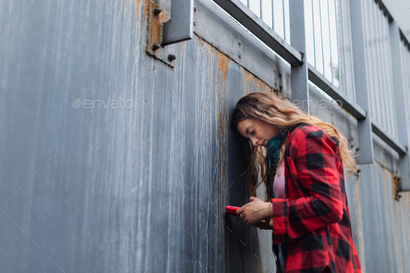 Gen Z girl outdoors in the city, feeling sad, anxious and alone ...