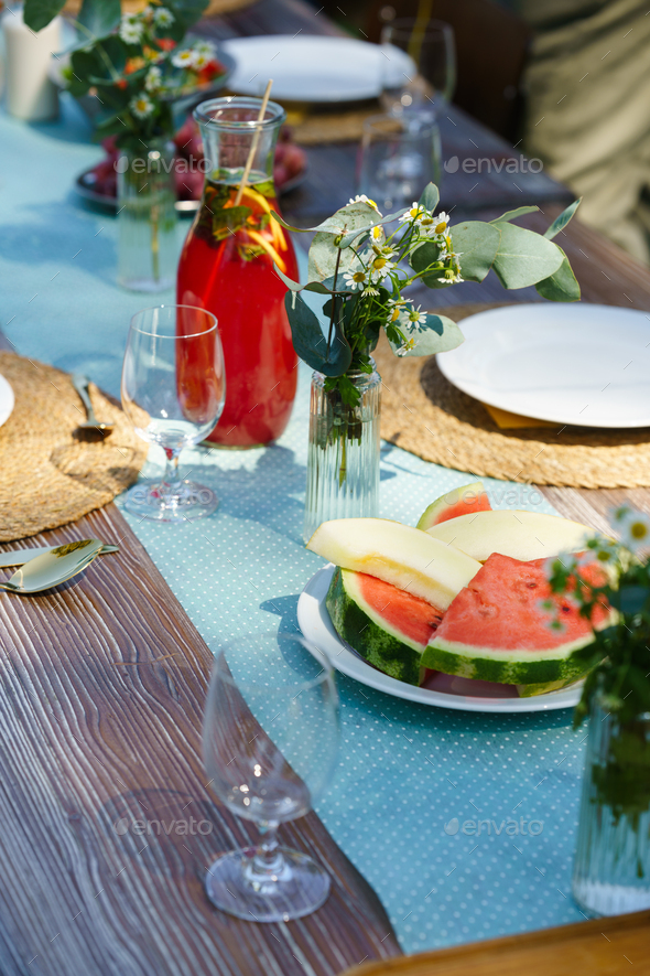 Close upof a set table at a summer garden party. Table setting with ...