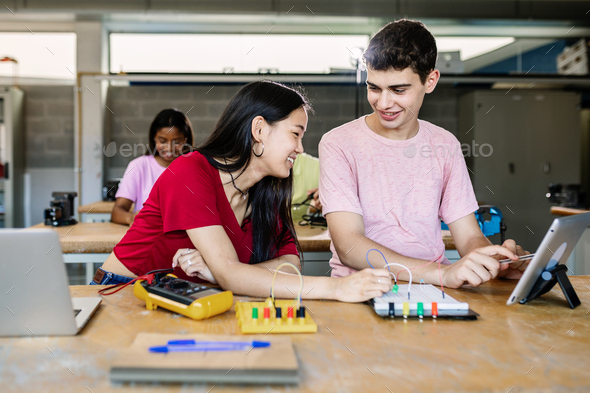 Young group of multiracial teenage students learning at technology ...