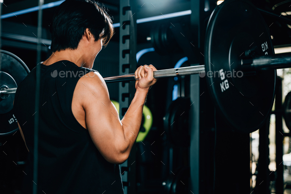 A determined bodybuilder lifting heavy barbells in the gym Stock Photo ...