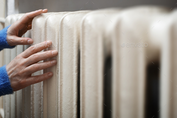 Caucasian female hands touching Hot Water Radiator. Home heating ...