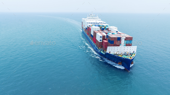 Aerial side view of smart cargo ship carrying container from custom ...