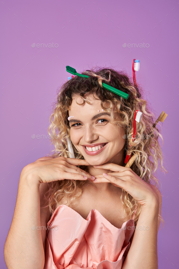 Joyful Woman In Pink Dress And Toothbrushes In Her Hair Hands Under