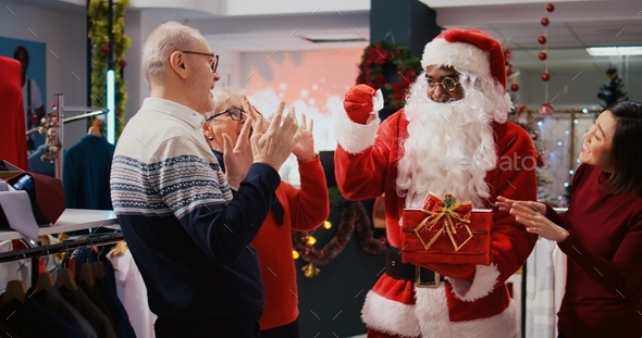 Santa Claus employee draws raffle winner Stock Photo by DC_Studio ...