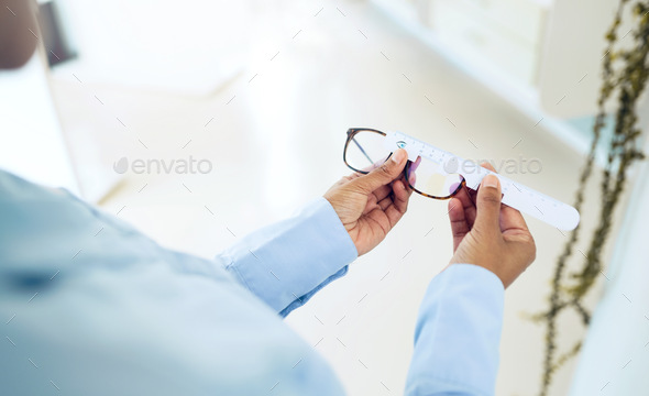Hands, measuring lens and frame of glasses, person in optometry clinic ...