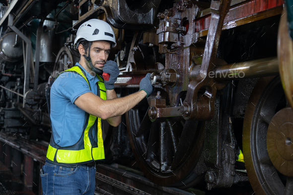 Portrait of Engineer train Inspect the train's diesel engine, railway ...