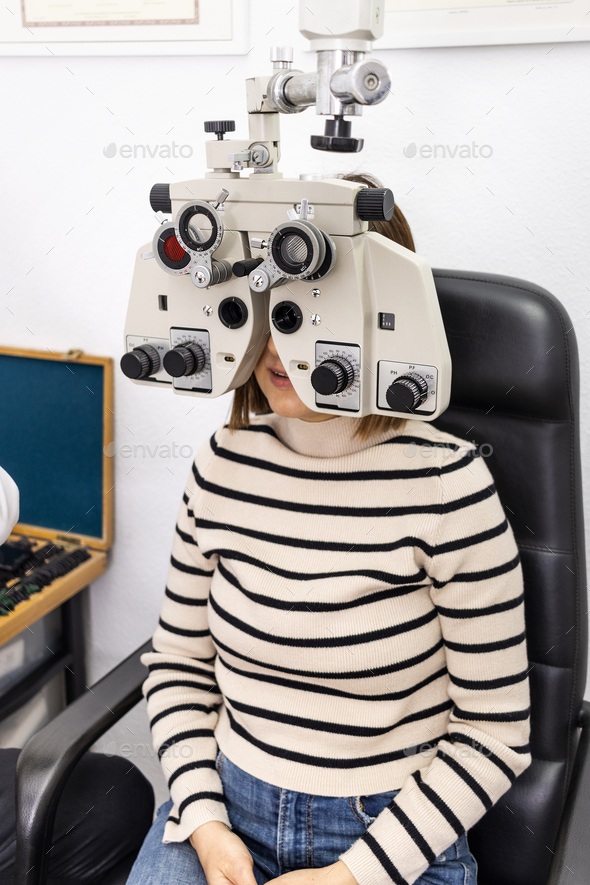 Eye Care Expertise: Redheaded Optometrist Conducting Vision Test on ...