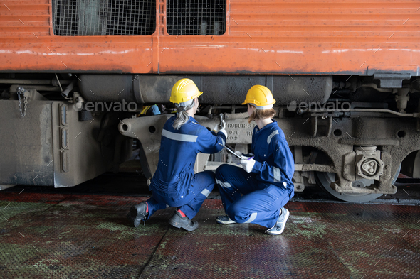 Portrait of Engineer train Inspect the train's diesel engine, railway ...