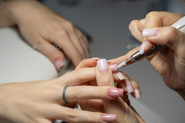 Female hands and tools for manicure, process of performing manicure ...