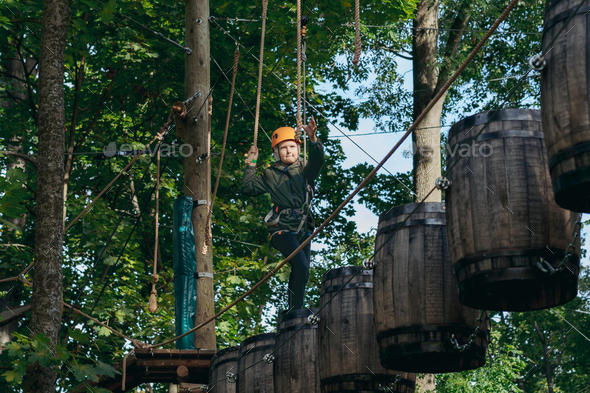 well equipped teenage boy in outdoor passing obstacle course. Active ...