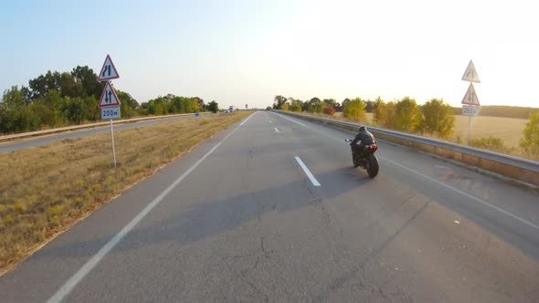 Follow to Biker Riding on Modern Sport Motorbike at Highway During ...