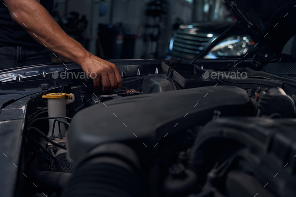 Close-up hand of male auto-mechanic checking battery terminals Stock ...