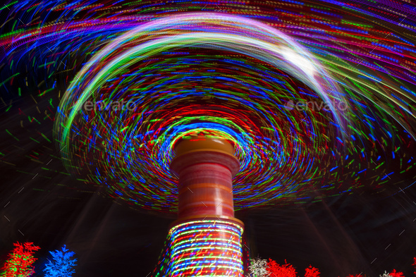 Carnival amusement park ride with swings. Spinning fair ride at night ...