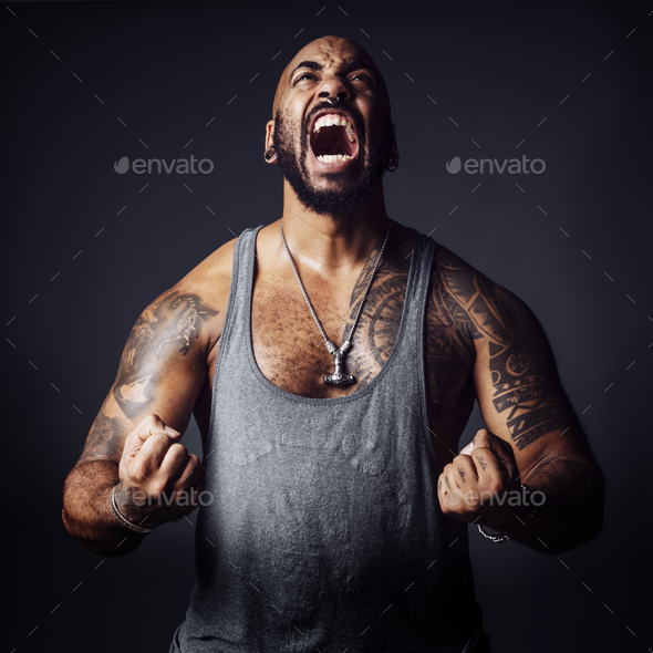 Muscular black man yelling with enraged attitude in a studio shot on ...